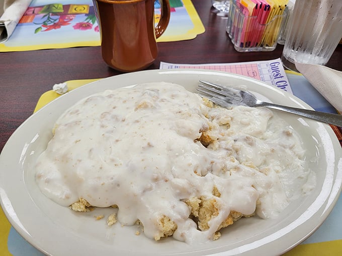 Biscuits and gravy so comforting it could end international conflicts—a creamy, peppery blanket covering tender islands of dough.