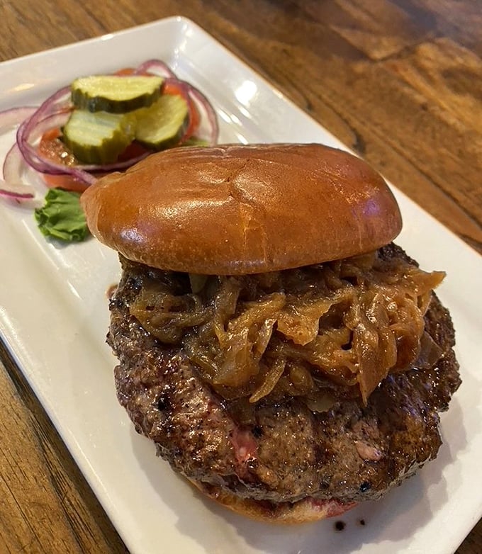 This bison burger topped with caramelized onions isn't just dinner—it's proof that sometimes the road less traveled tastes significantly better.
