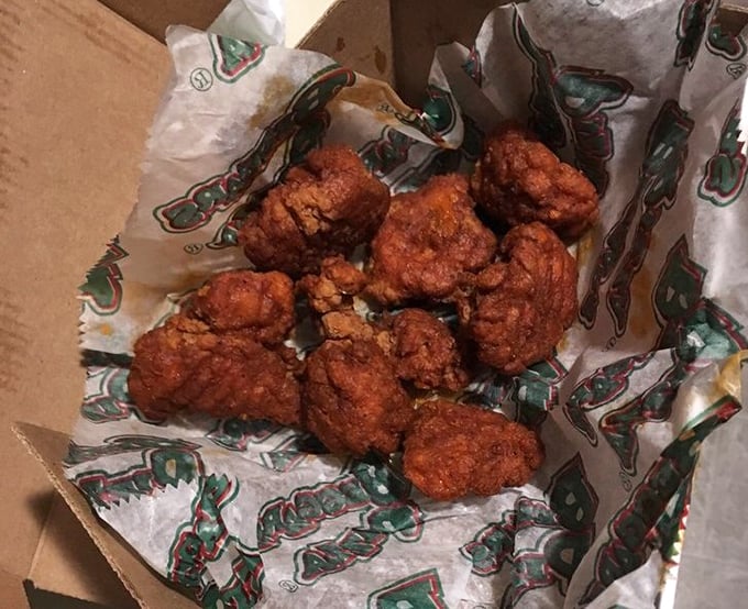 Boneless wings nestled in their takeout container like little nuggets of spicy gold—proof that good things come in unassuming packages.