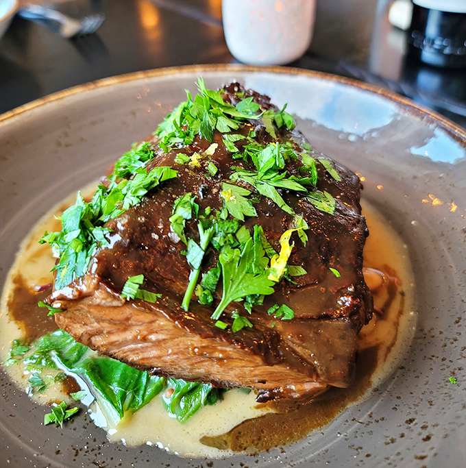 These braised short ribs don't just fall off the bone—they practically leap onto your fork, swimming in a sauce you'll want to bottle and take home.