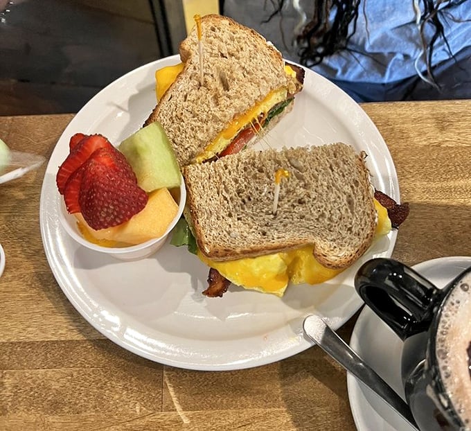 The breakfast sandwich—civilization's greatest achievement since indoor plumbing. Fresh fruit on the side keeps your conscience as clean as the plate will be.