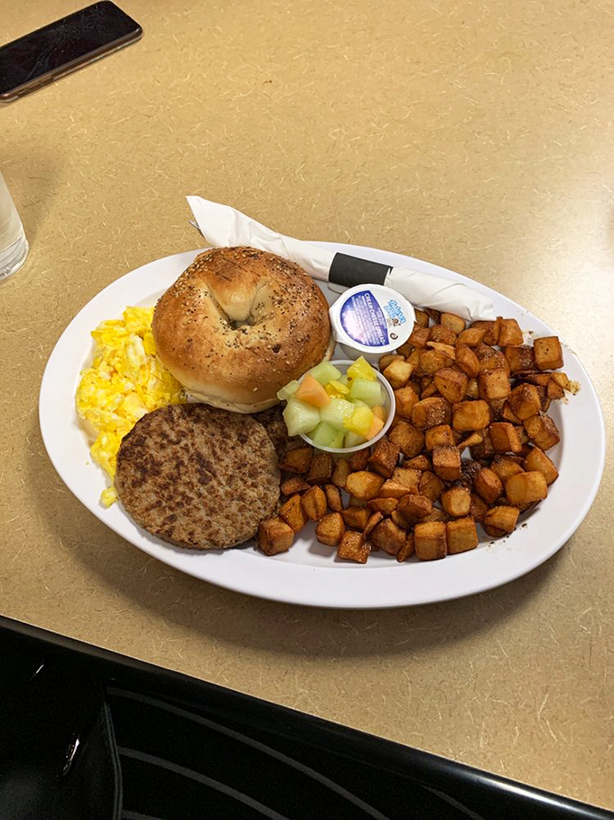 Breakfast platters that mean business – a perfectly toasted bagel, eggs, sausage, and those home fries that somehow taste better than the ones you make. 