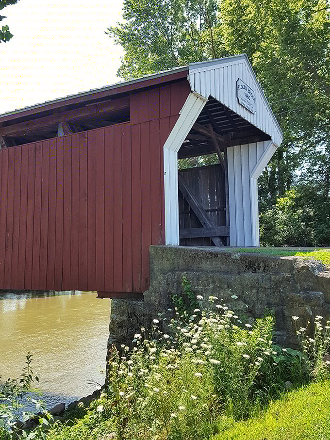 That classic red-and-white color scheme isn't just for barns. The bridge's side view reveals how it hugs the riverbank like it was meant to be there.