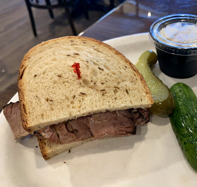 A brisket sandwich that doesn't need fancy trimmings to impress. Just meat, bread, and a pickle—sometimes simplicity is the ultimate sophistication.