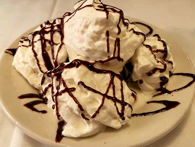 Cloud-like whipped cream drizzled with chocolate sauce—proof that after conquering a steak, there's always room for a little something sweet.