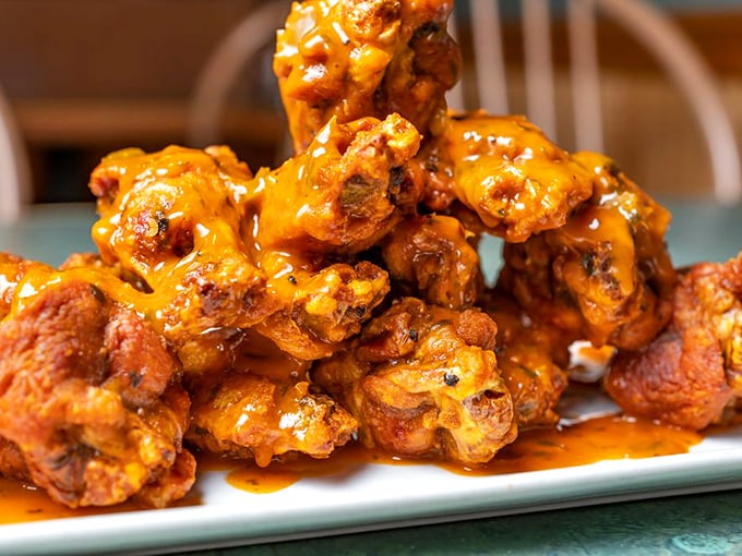 Buffalo wings piled high and proud – the kind that require extra napkins and zero apologies.