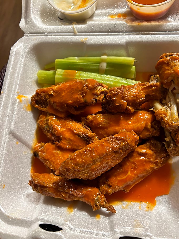 Buffalo wings that don't mess around—crispy, saucy, and served with the obligatory celery sticks for that token vegetable appearance.