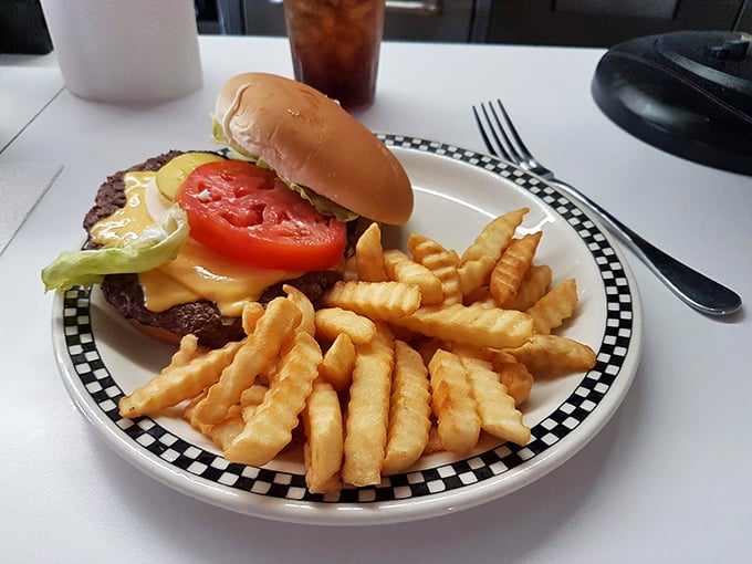The burger arrives like a juicy work of art—melted cheese, fresh veggies, and a patty that makes plant-based alternatives weep with inadequacy.
