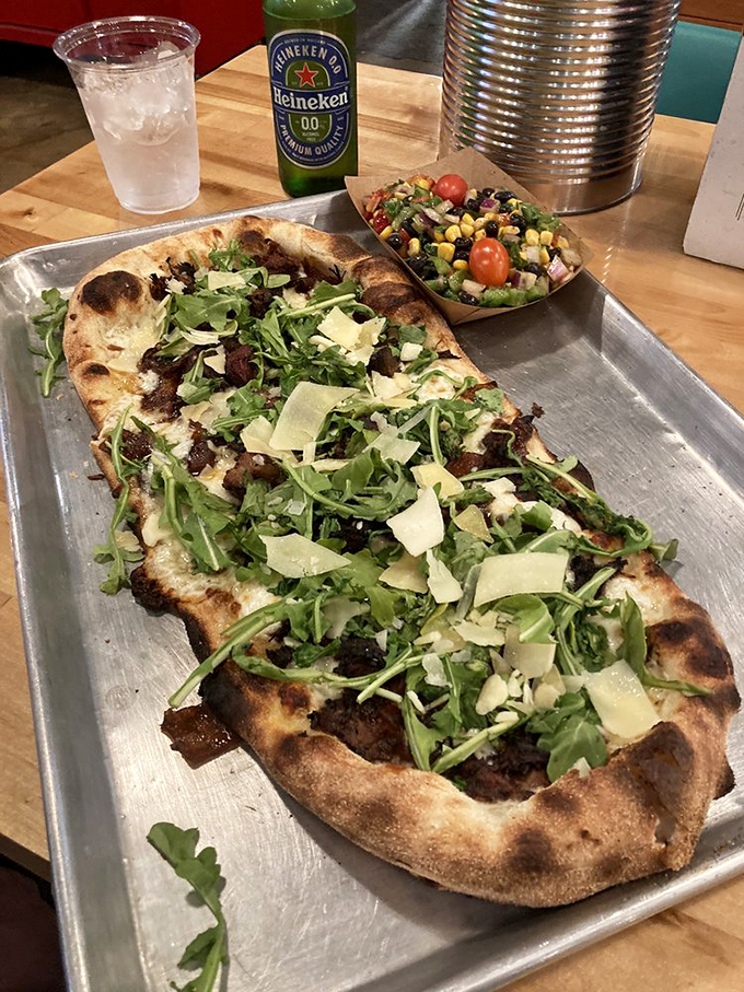 Flatbread that dares to dream bigger, topped with arugula and what appears to be burnt ends—proof that BBQ and pizza were meant to be together.