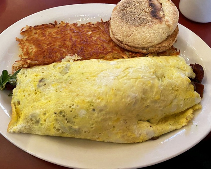 This isn't just an omelet—it's a golden-hued sleeping bag for delicious fillings, accompanied by a hash brown crispy enough to make a potato proud.