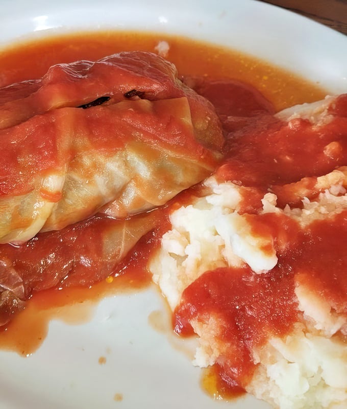 Cabbage rolls lounging in tomato sauce like they're at a spa—comfort food that whispers "someone's grandmother perfected this recipe."
