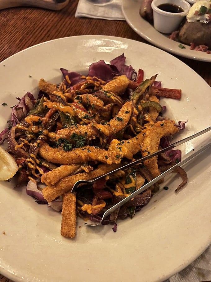 Calamari that's crispy, tender, and served on a bed of purple cabbage—like ocean jewelry displayed on royal velvet.
