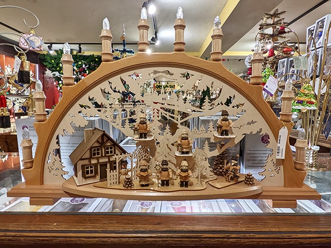 This intricate wooden candle arch—or Schwibbogen—tells a complete winter story through delicate cutouts and miniature figurines.