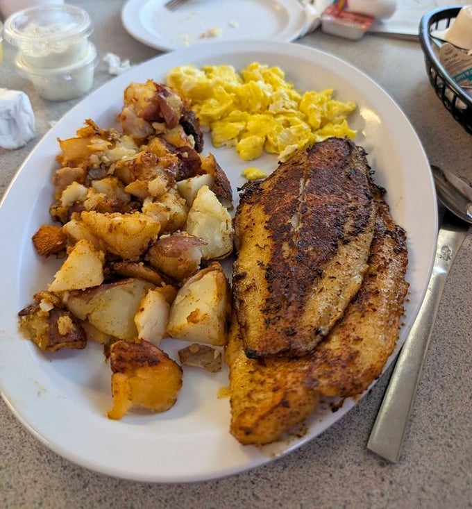Golden-crisp fish, sunshine-yellow eggs, and potatoes that have clearly been on speaking terms with butter. Florida breakfast at its finest.