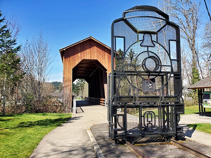 The Chambers Covered Bridge stands as wooden testament to craftsmanship that predates planned obsolescence. That locomotive sculpture? Just the cherry on top.