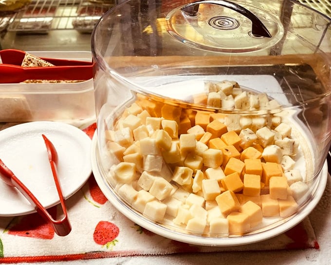 Cheese cubes under glass – the buffet appetizer that somehow tastes better when you're using those little tongs to grab "just one more."