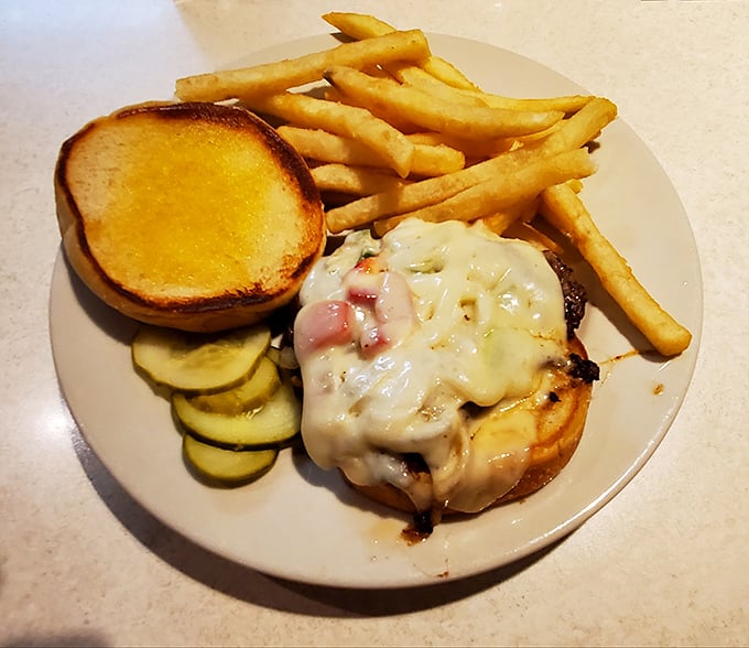 This isn't just a burger—it's an edible love letter to American comfort food, complete with melted cheese and those perfectly golden fries.