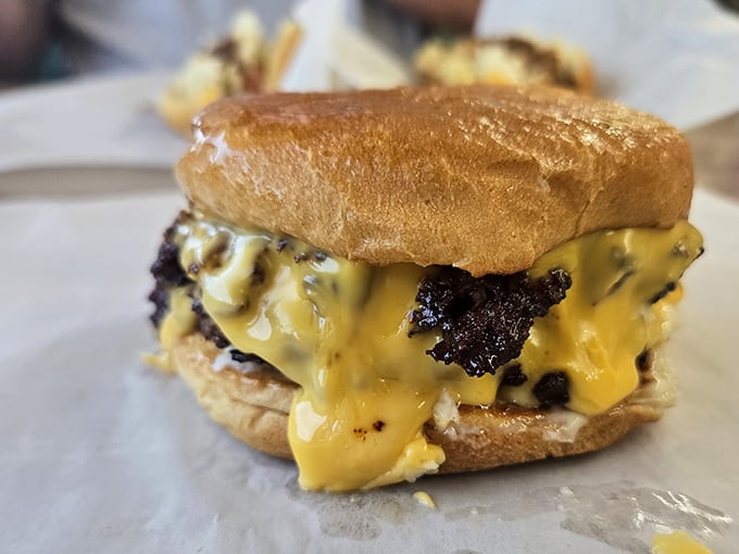 The melted cheese waterfall that launched a thousand road trips. Not all heroes wear capes—some wear sesame seed buns.
