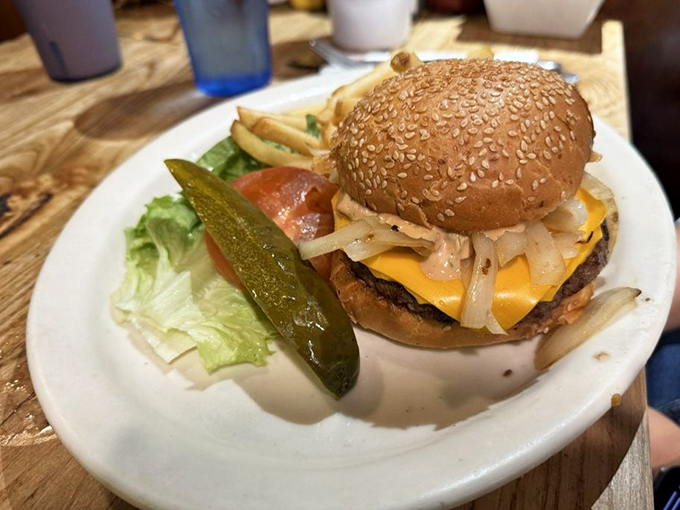 The cheeseburger—America's greatest contribution to world peace. This one comes with the obligatory pickle spear standing guard.