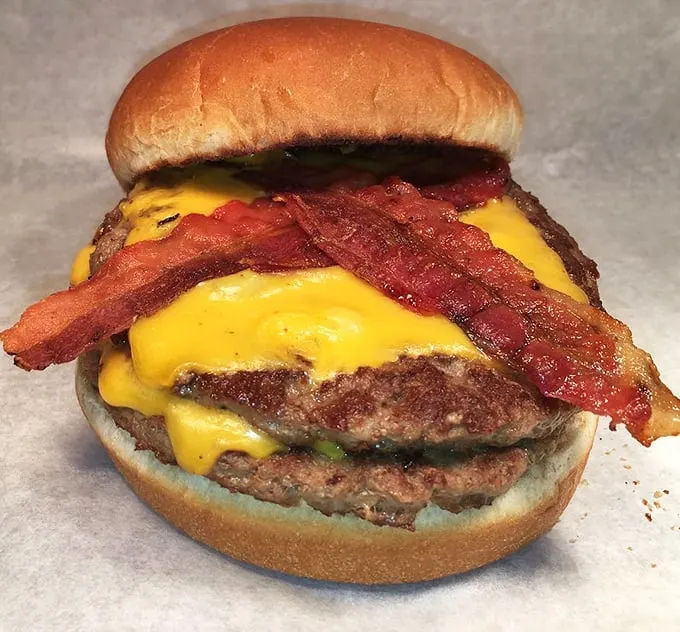 Behold the double bacon cheeseburger—where beef meets cheese meets bacon in a summit more productive than most political ones.