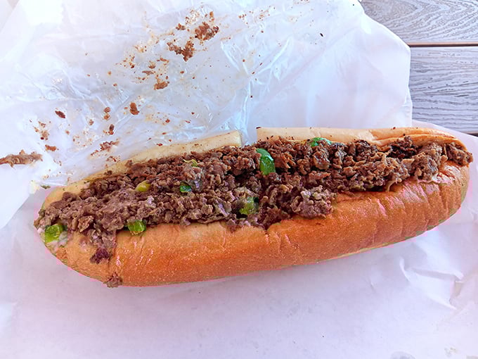 The star of the show – a cheesesteak in its natural habitat. Chopped beef and green peppers mingling on a roll like old friends at a reunion.