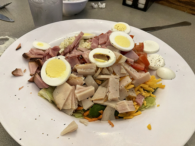 The chef's salad showcases garden-fresh ingredients arranged like a rainbow, making healthy eating feel like a celebration of flavors.