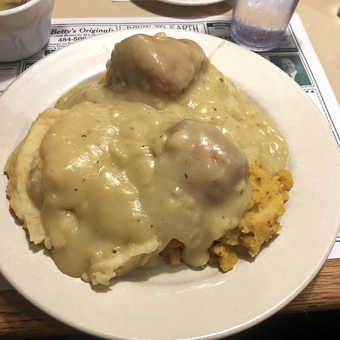 Chicken croquettes swimming in gravy atop mashed potatoes—comfort food so nostalgic it should come with a playlist of songs from your high school years.