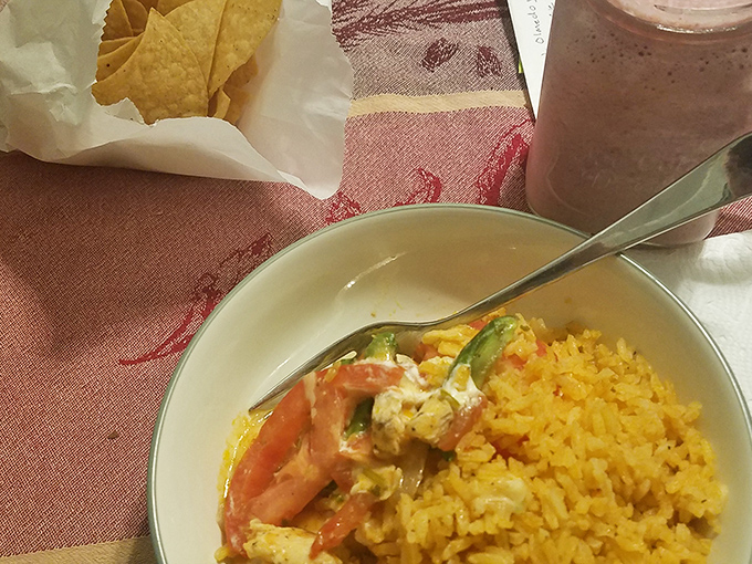A fiesta in a bowl—vibrant chicken enchilada with sunny yellow rice that brightens both the plate and your day.