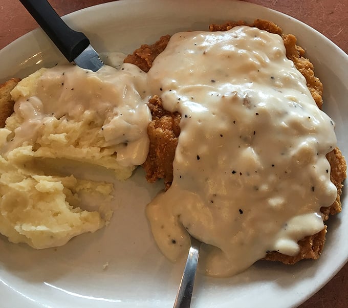 Country fried steak smothered in gravy alongside cloud-like mashed potatoes—comfort food that gives you a warm hug from the inside out.