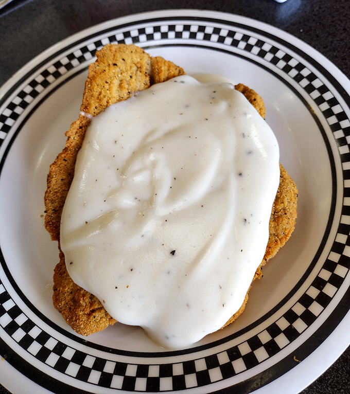The star of the show—chicken fried steak wearing its cream gravy like a royal robe. No Instagram filter required.