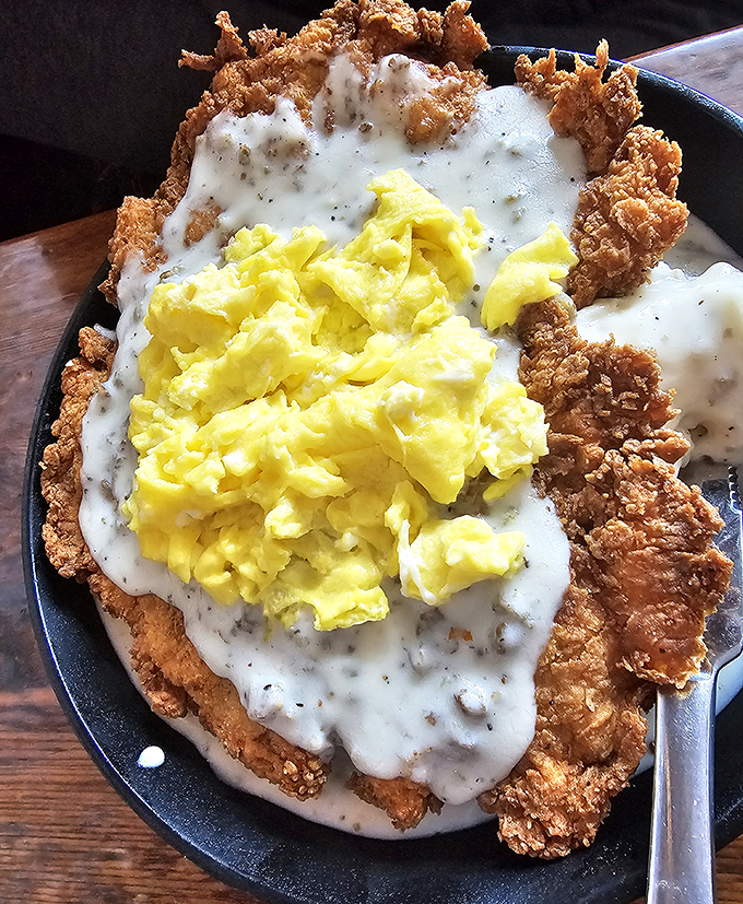 Chicken fried steak crowned with gravy and sunny eggs—the breakfast equivalent of hitting the Texas trifecta.