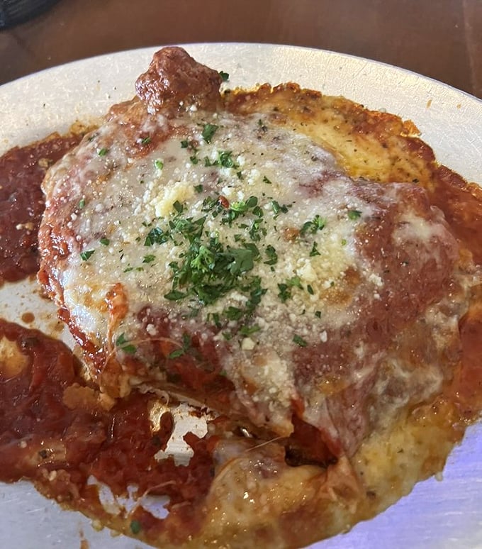 Chicken parmigiana swimming in a sea of red sauce with melted cheese acting as a life raft. This isn't food—it's edible therapy.
