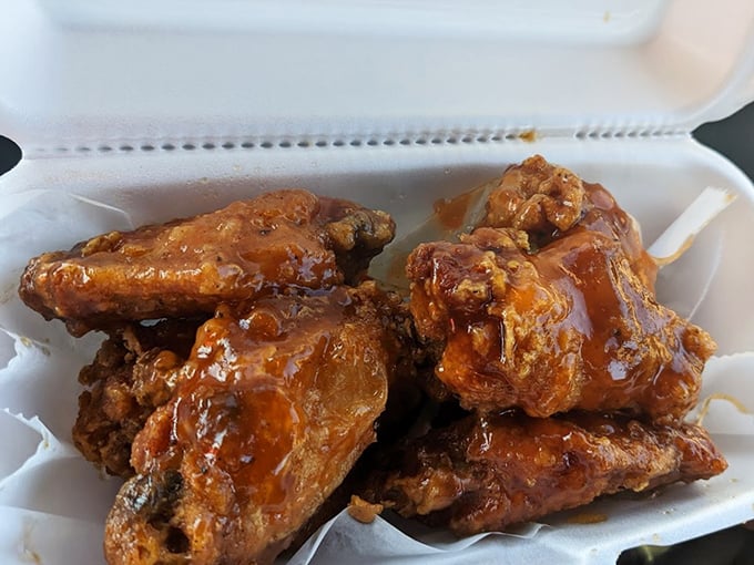These wings aren't just sauced, they're baptized – glistening with a sticky glaze that promises to redecorate your shirt and your taste buds.