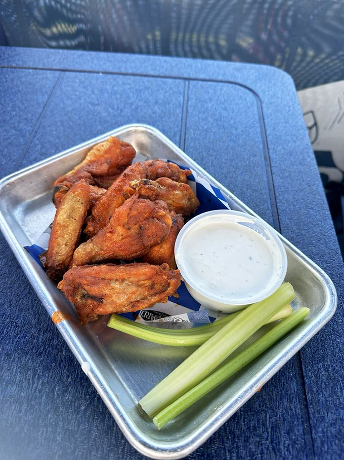 These wings aren't just crispy—they've achieved that mythical texture that makes you wonder if the kitchen has somehow defied the laws of culinary physics. 