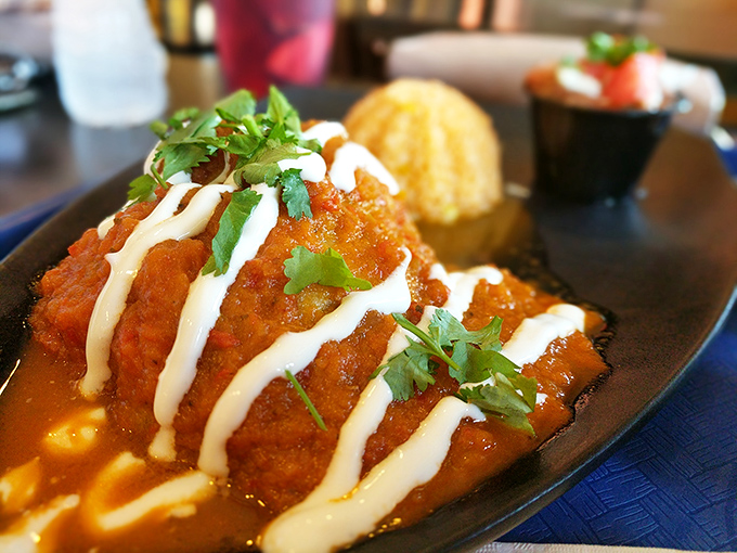 Chilaquiles that could cure any ailment known to mankind—crispy tortilla chips swimming in vibrant sauce, crowned with crema and fresh cilantro.