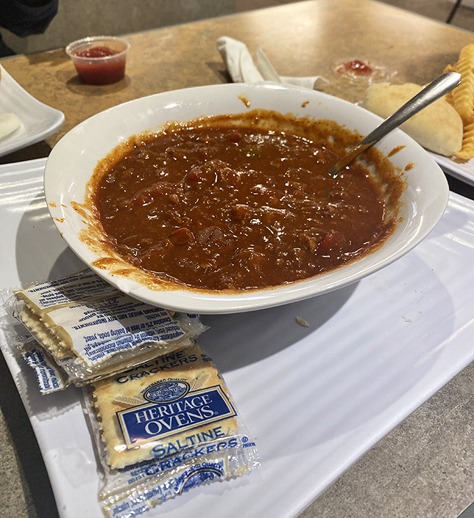 A bowl of chili so hearty it could qualify as a main character in a country song, served with crackers for that perfect textural counterpoint.