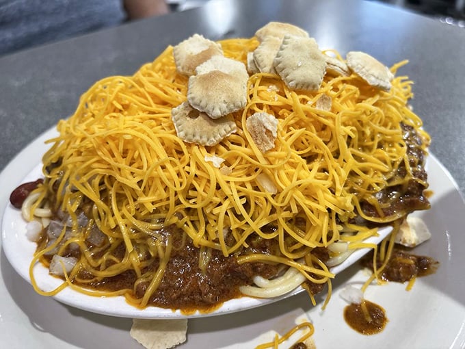 Behold the legendary Cincinnati "way"—spaghetti smothered in aromatic chili and crowned with a blizzard of finely shredded cheddar.