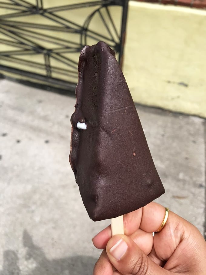 The chocolate-dipped key lime pie on a stick—proof that someone looked at perfection and thought, "You know what this needs? A tuxedo."