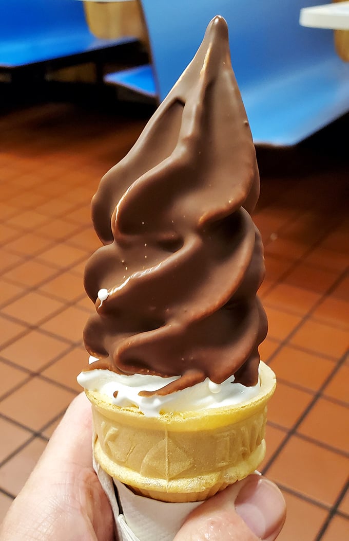 The chocolate-dipped cone—proof that some of life's greatest pleasures don't need reinvention, just consistent execution and a sturdy napkin.