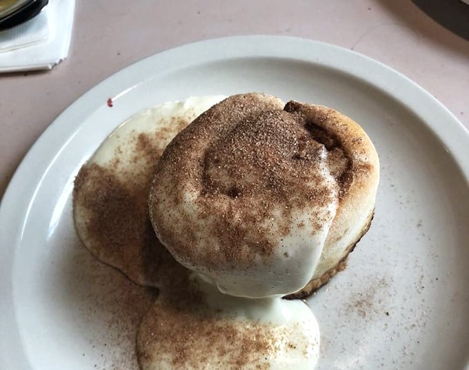 This cinnamon roll isn't just breakfast—it's dessert masquerading as a morning meal, and nobody's complaining about this delicious deception.