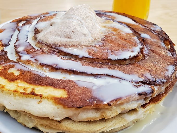 Cinnamon roll pancakes crowned with icing – proof that breakfast dessert isn't an oxymoron, it's a life philosophy.
