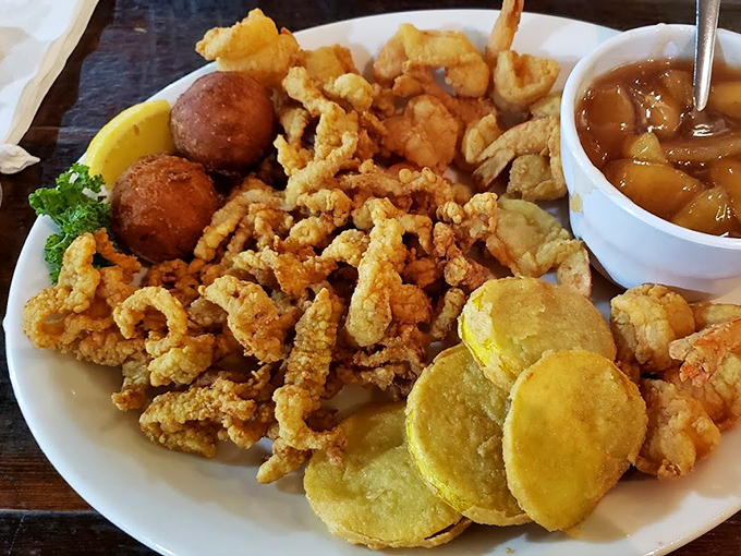 A symphony of textures on one plate—crispy seafood, golden fried squash, and those addictive hush puppies that keep stealing the spotlight.