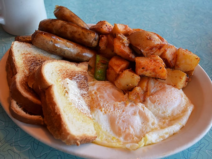 Breakfast fundamentals executed flawlessly—golden sausages, sunny eggs, and toast with home fries that prove sometimes the classics need no improvement.