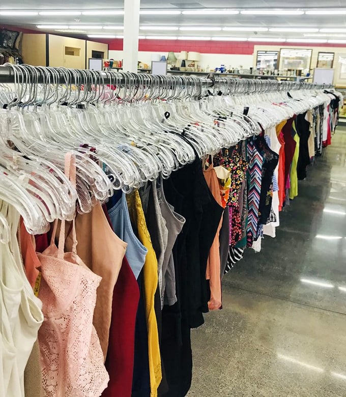 The rainbow road of fashion possibilities. Each hanger holds not just clothing, but potential new identities waiting to be discovered and worn.