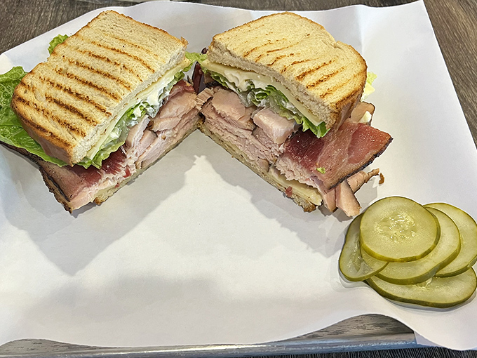 Even the sandwich game is strong here – layers of smoky meat between grilled bread with those bright pickle coins standing guard.