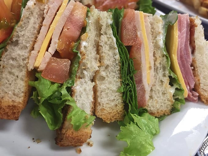 The club sandwich—architectural marvel of the diner world. Layers of goodness stacked so high you'll need to strategize your first bite.