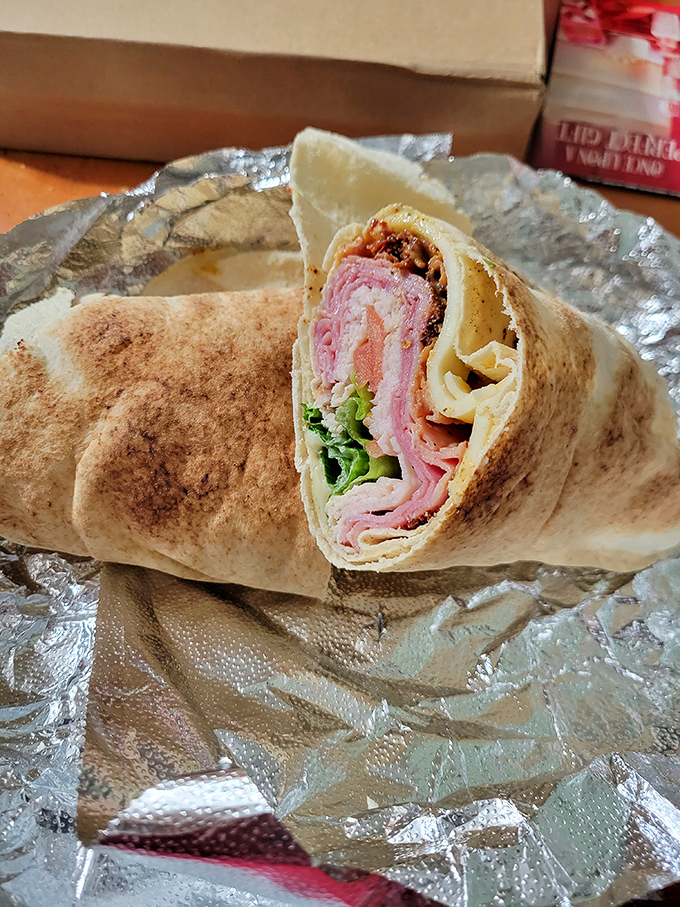This wrap isn't just holding meats and veggies—it's cradling dreams. The cross-section reveals the architectural genius behind every bite.