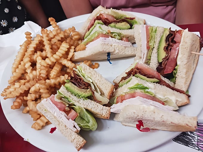 The club sandwich: architectural marvel of the lunch world. Those crinkle-cut fries aren't just sides—they're supporting characters in this midday drama.