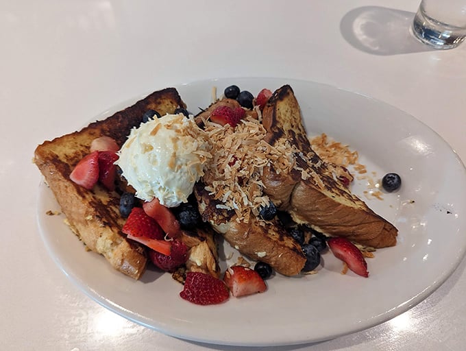 French toast architecture at its finest—layers of bread, berries, and cream stacked higher than your weekend expectations. Worth every calorie.