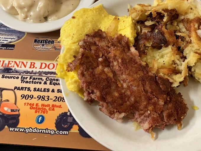 Breakfast perfection on a plate: golden hash browns, farm-fresh eggs, and that corned beef hash that haunts your dreams in the best possible way.